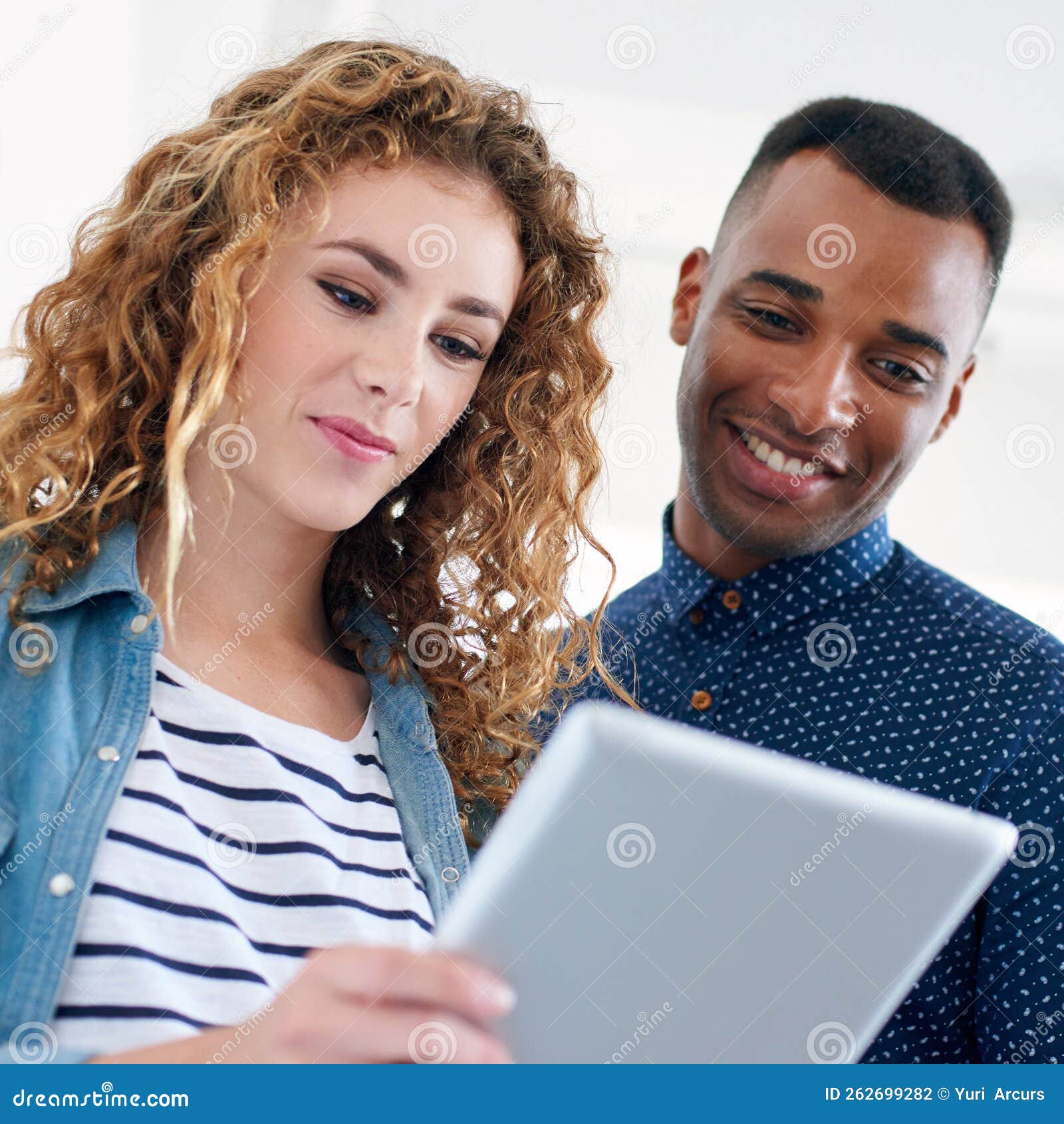 Well Get Any Job Done...together. Two Young Colleagues Using a Digital ...