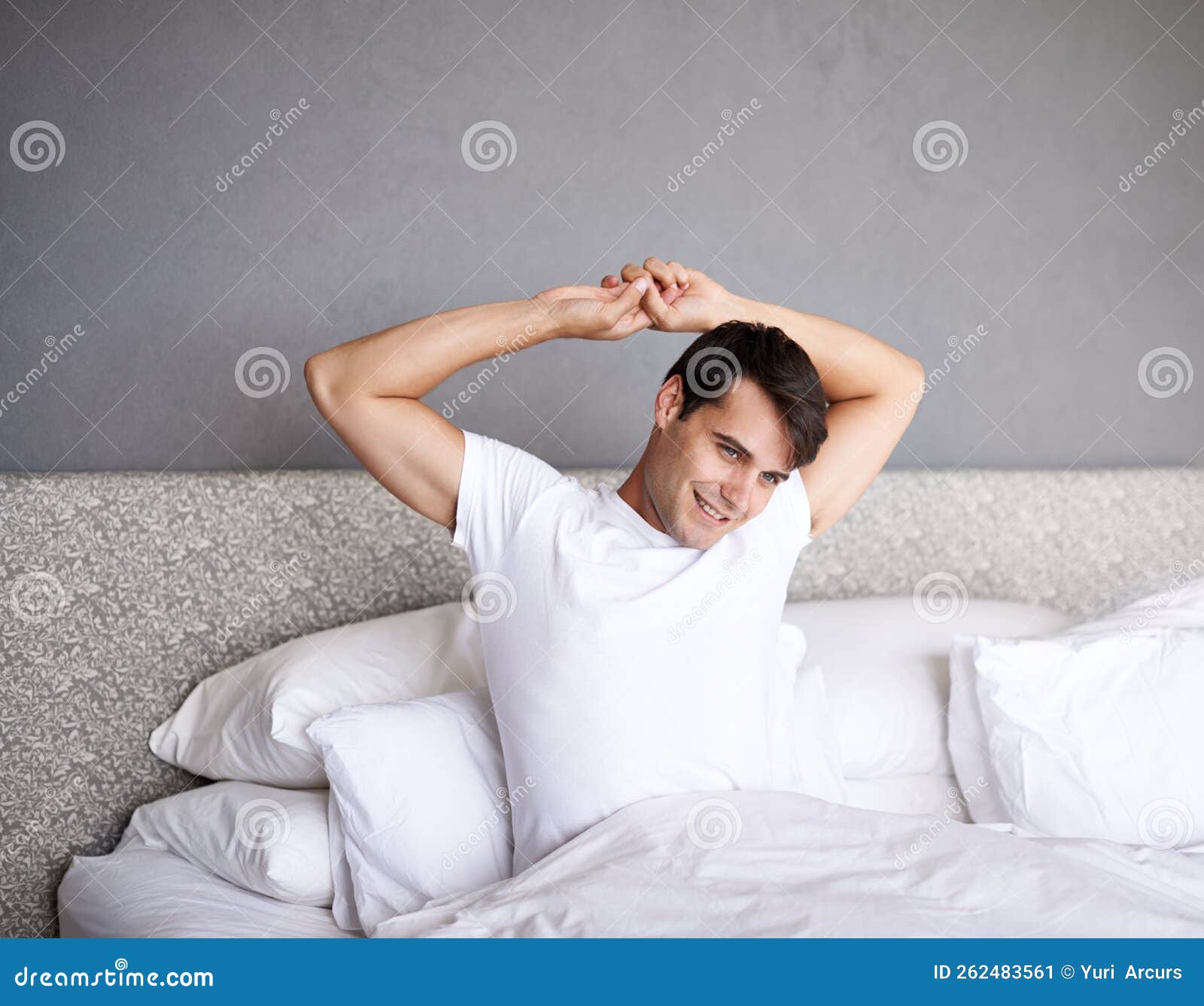 Well Rested. a Young Man Stretching in Bed while Waking Up. Stock Image ...
