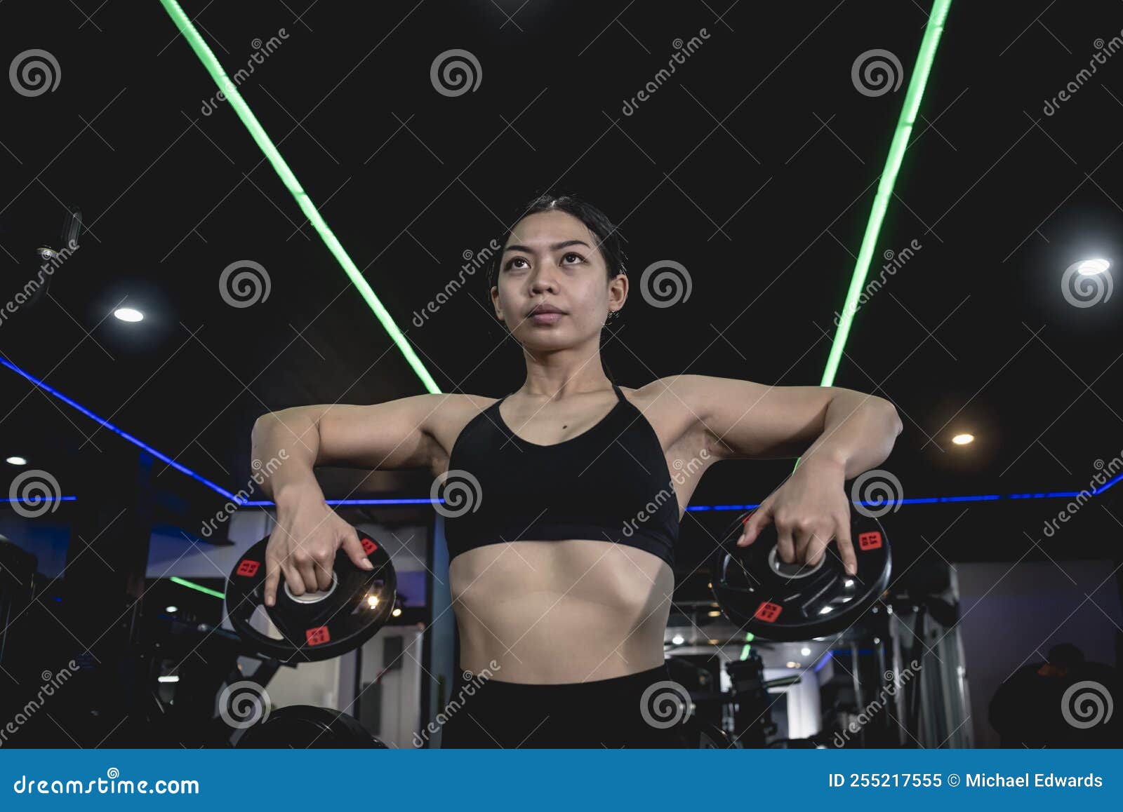 An Well Trained Woman Performs Upright Rows with 2 Barbell Plates ...