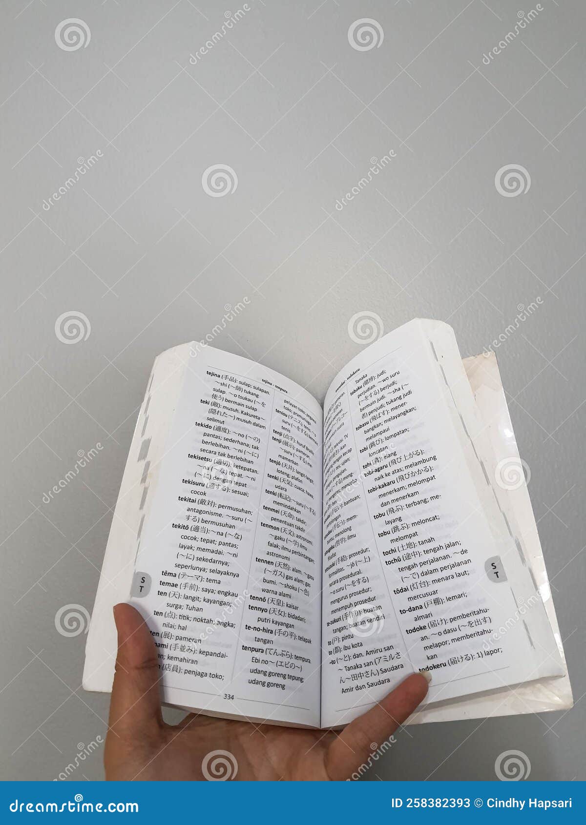 West Java, August 2022. a Hand is Holding a Japanese-Indonesian ...