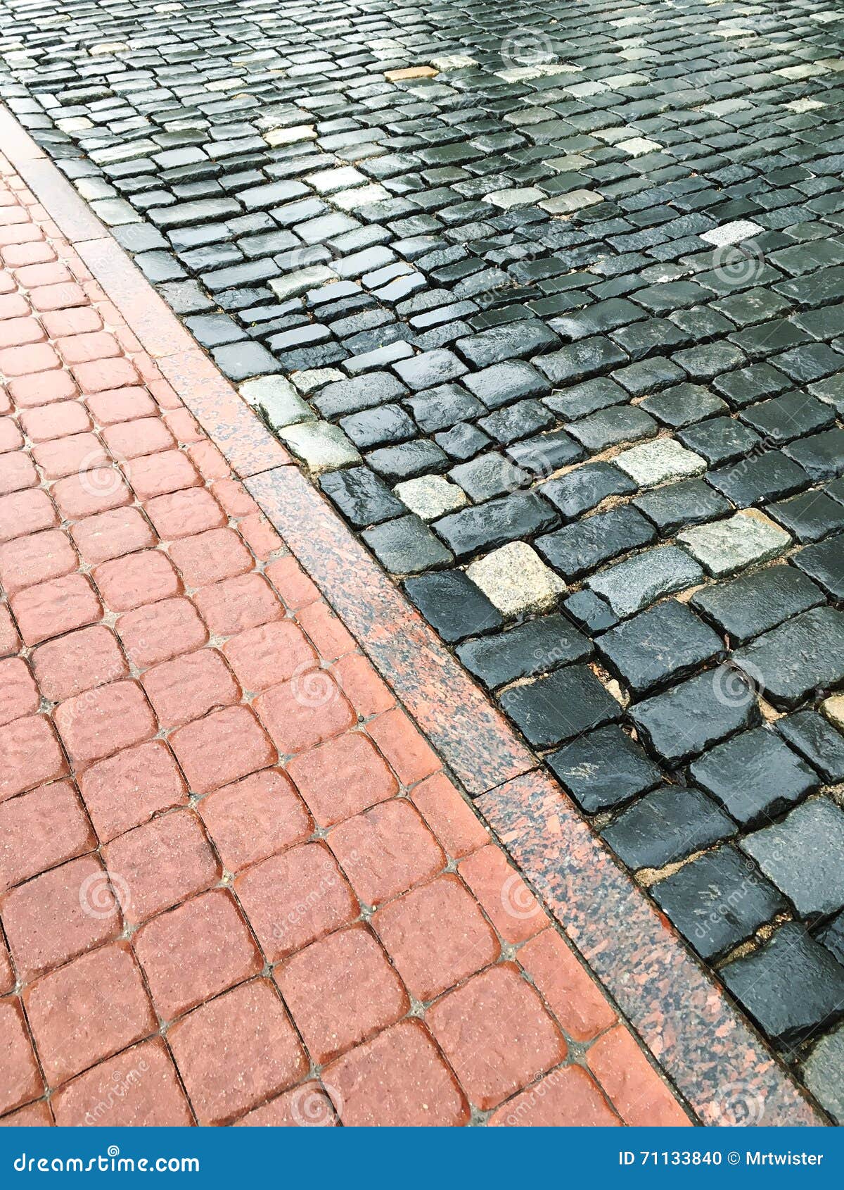 Wet Block Sidewalk and Rough Cobblestone Road Stock Photo - Image of ...