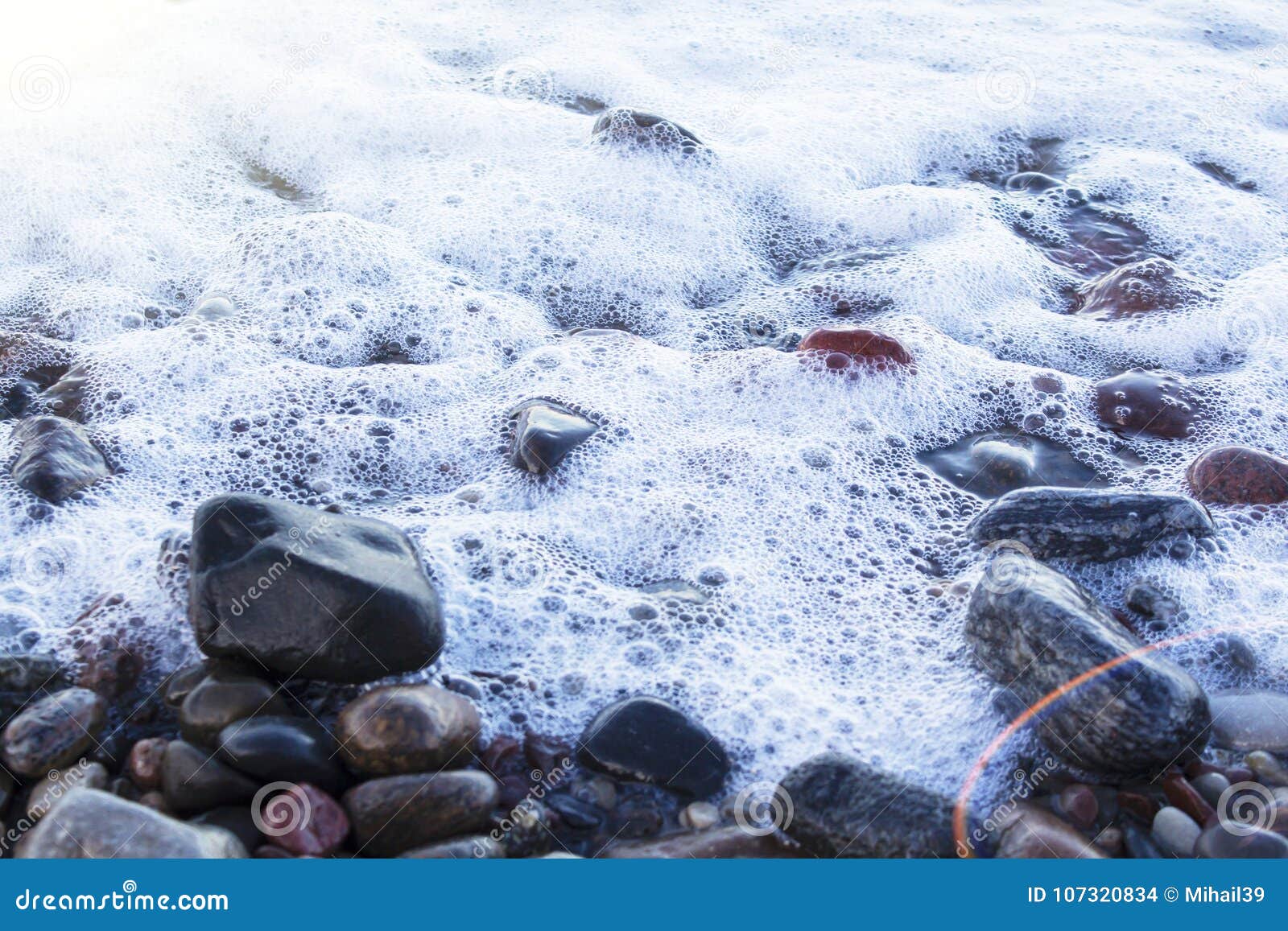 Wet Bright Shining Different Colored Pebble Stones and Sea Foam. Stock ...