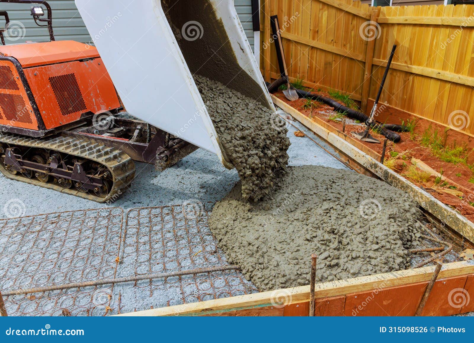 Wet Cement is Poured into Framework during Foundation Construction ...