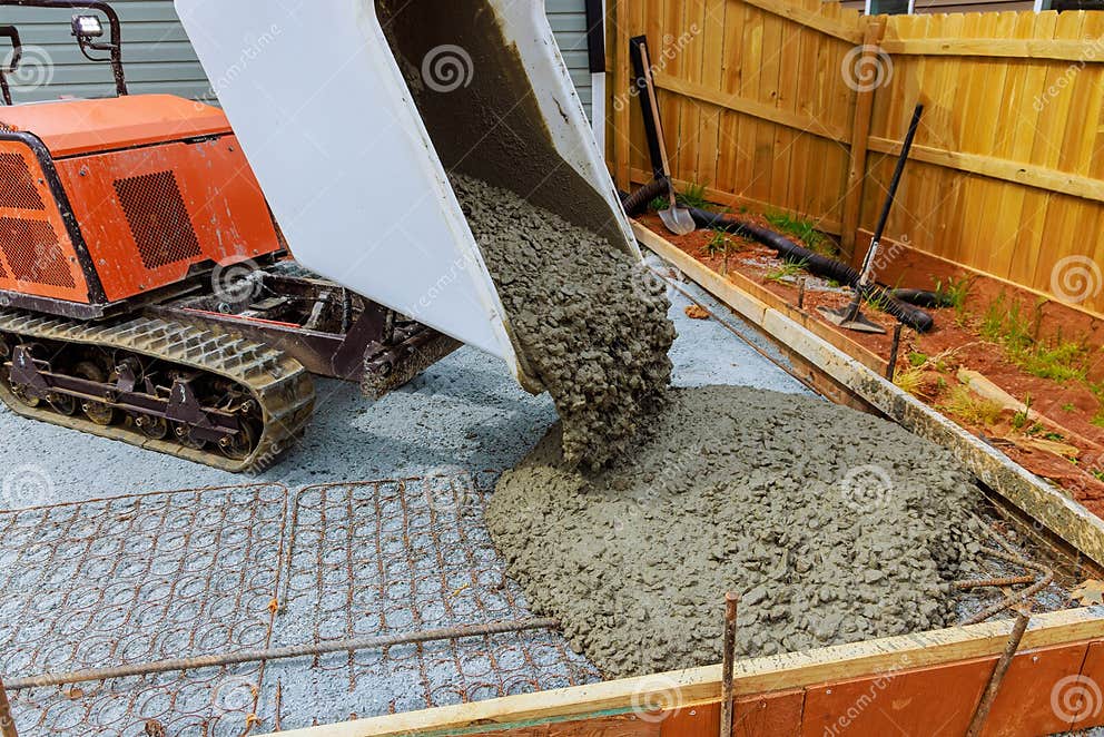 Wet Cement is Poured into Framework during Foundation Construction ...