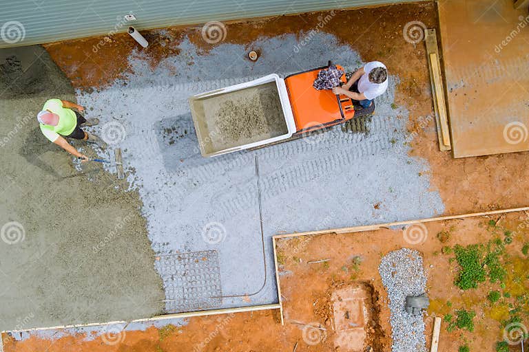 Wet Cement is Poured into Framework Using a Self Dumping Track Concrete ...