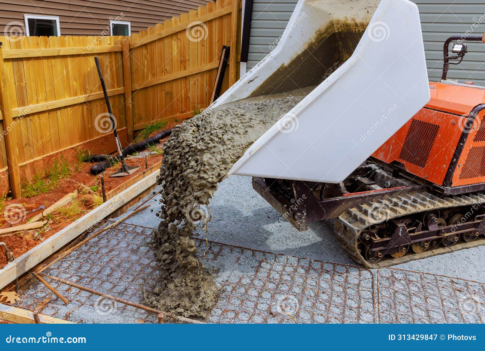 Wet Cement is Poured into Framework Using a Self Dumping Track Concrete ...