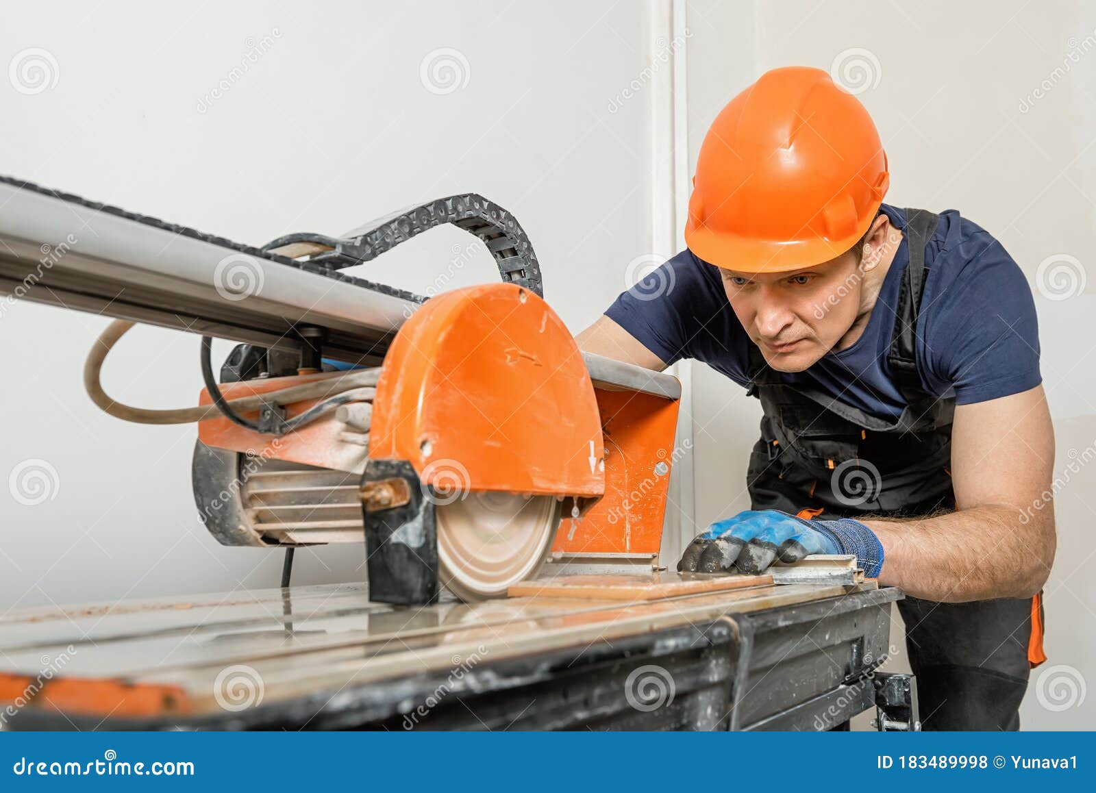 Wet cutting a ceramic tile stock photo. Image of tile - 183489998