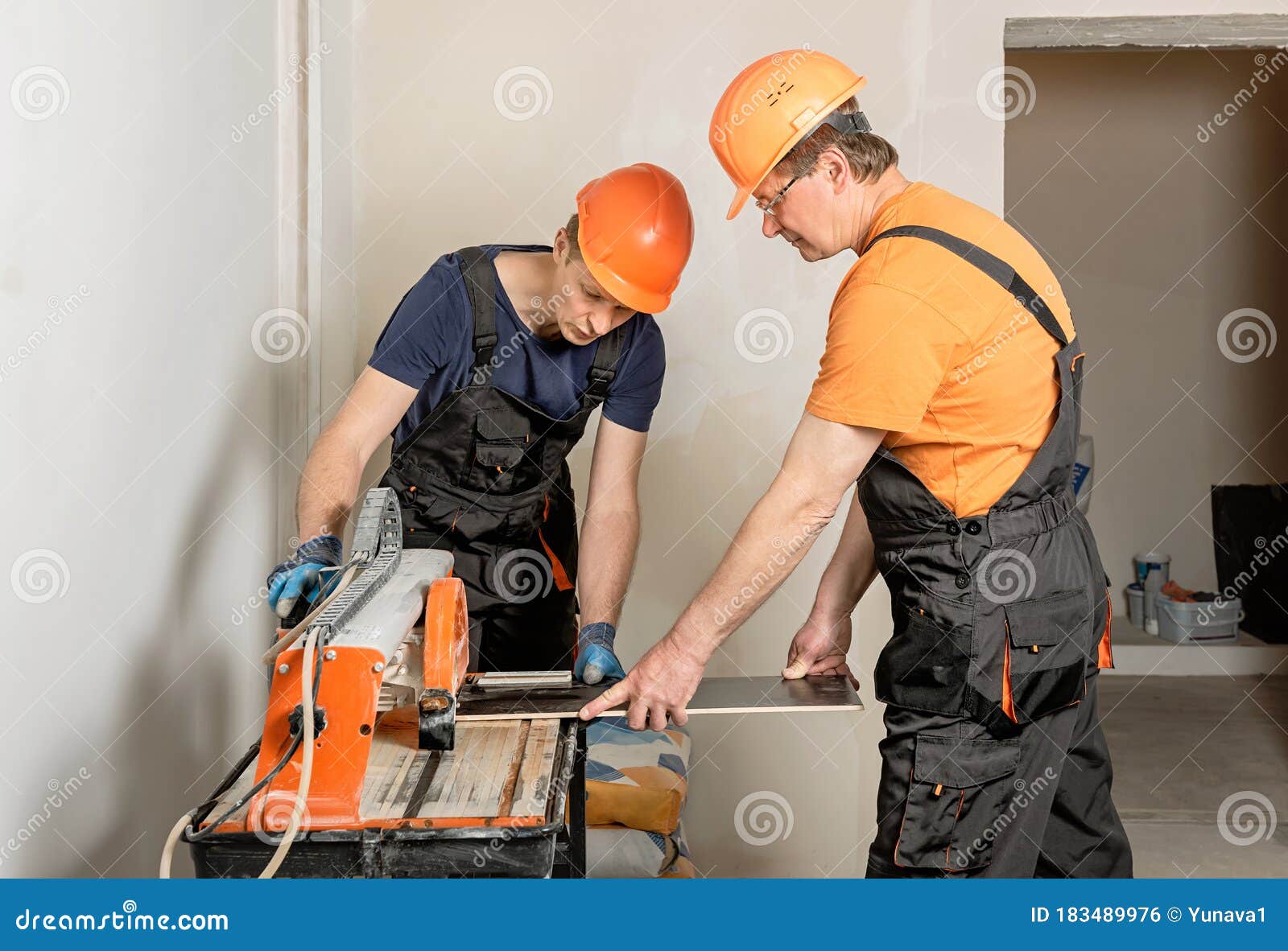 Wet cutting a ceramic tile stock photo. Image of builder - 183489976