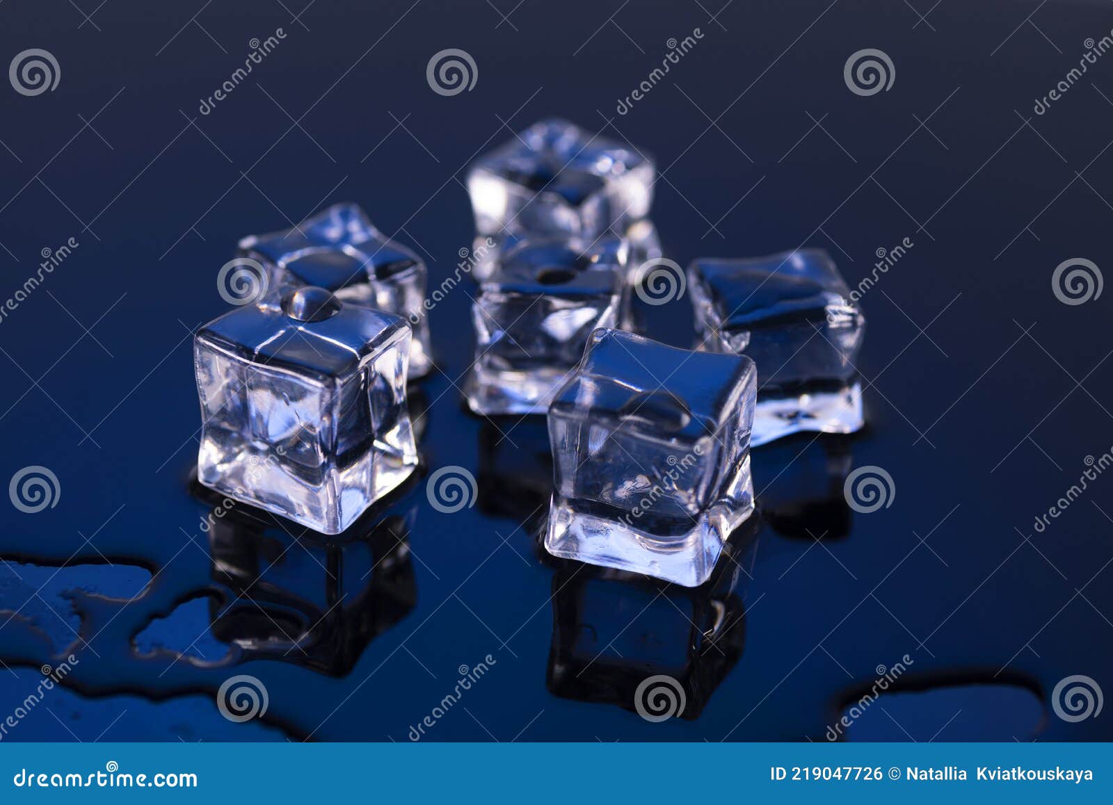 Wet Ice Cubes in a Puddle of Water on a Blue Background Stock Photo ...