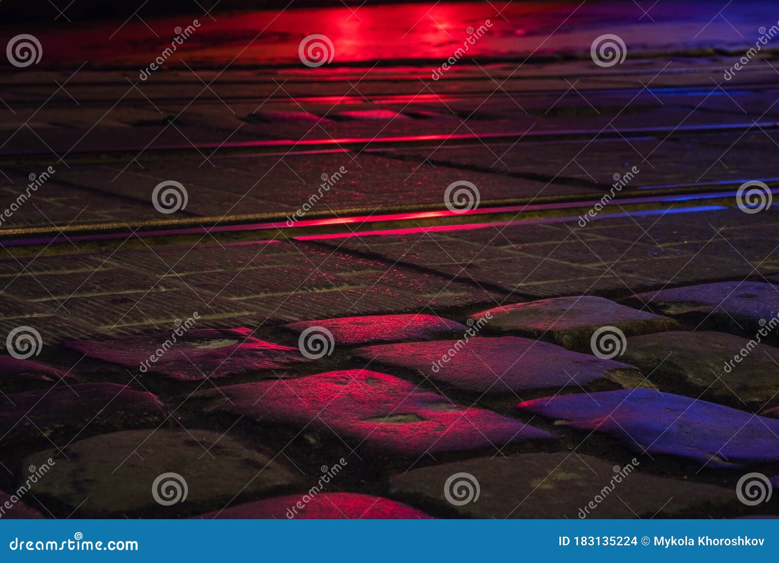 Illuminated by Red Light Cobblestone Street at Night Stock Photo ...