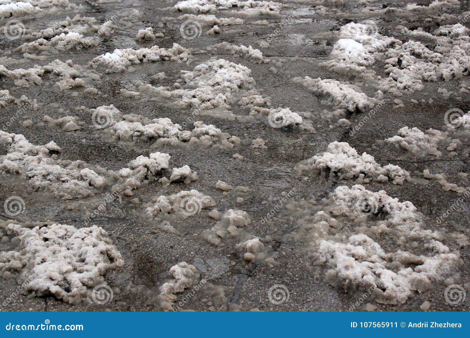 Wet slushy snow on asphalt stock image. Image of weather - 107565911