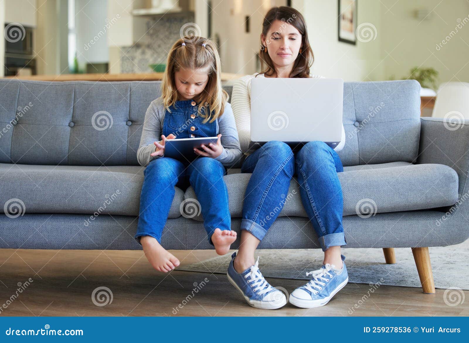 Weve Both Got Work To Do A Young Mother And Daughter Using A Laptop And Digital Tablet On The