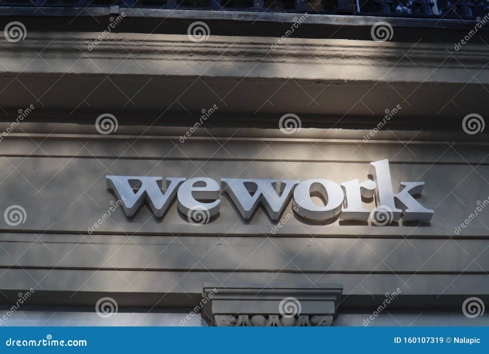 A Wework sign in shadows. editorial stock image. Image of space - 160107319
