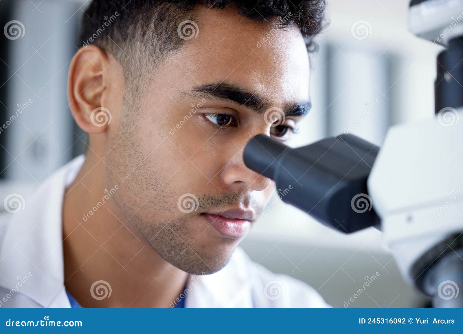 What Do we Have Here. Shot of a Young Man Using a Microscope in a Lab ...