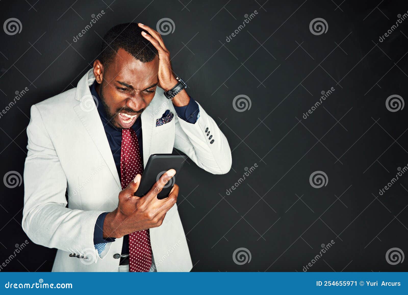 What the Hell is Wrong with this Thing. a Young Businessman Looking at ...