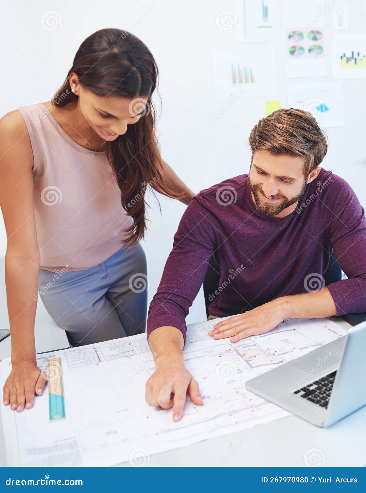 What about this. Two Young Architects Looking Over Some Building Plans ...