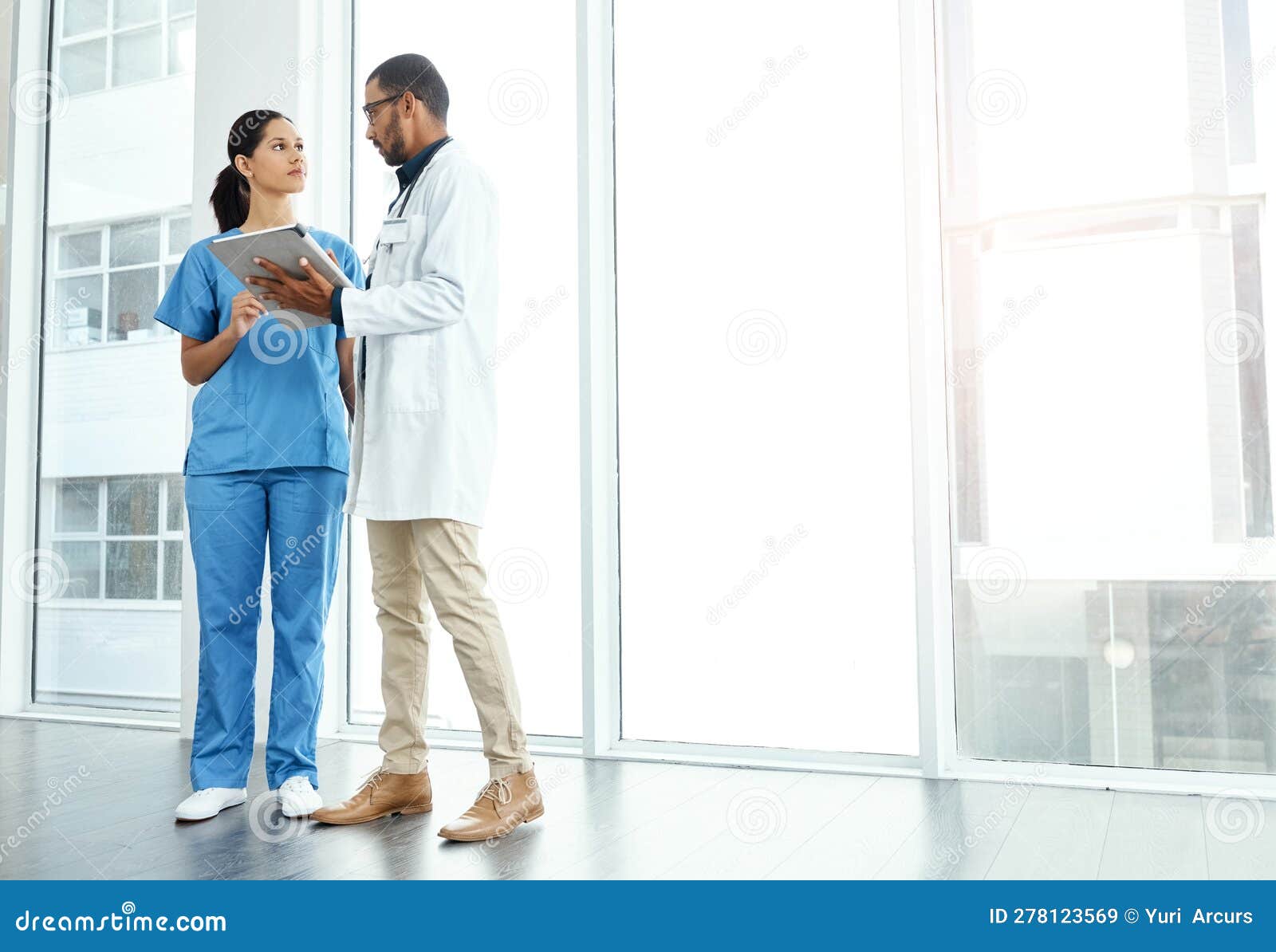 What are Your Thoughts on this. Two Young Doctors Using a Digital ...