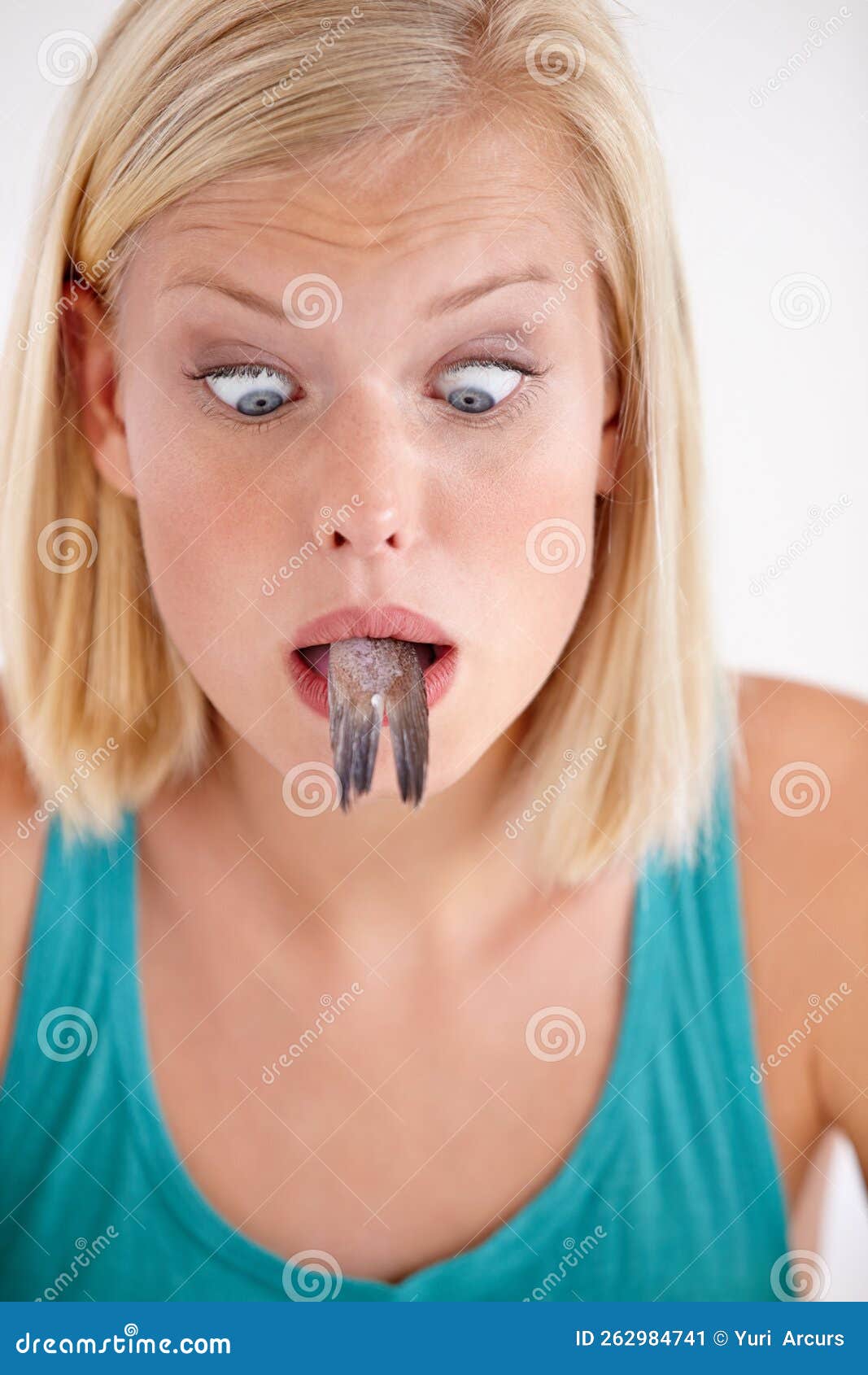 Whatever is this. a Young Woman Pulling a Face with a Fish in Her Mouth ...