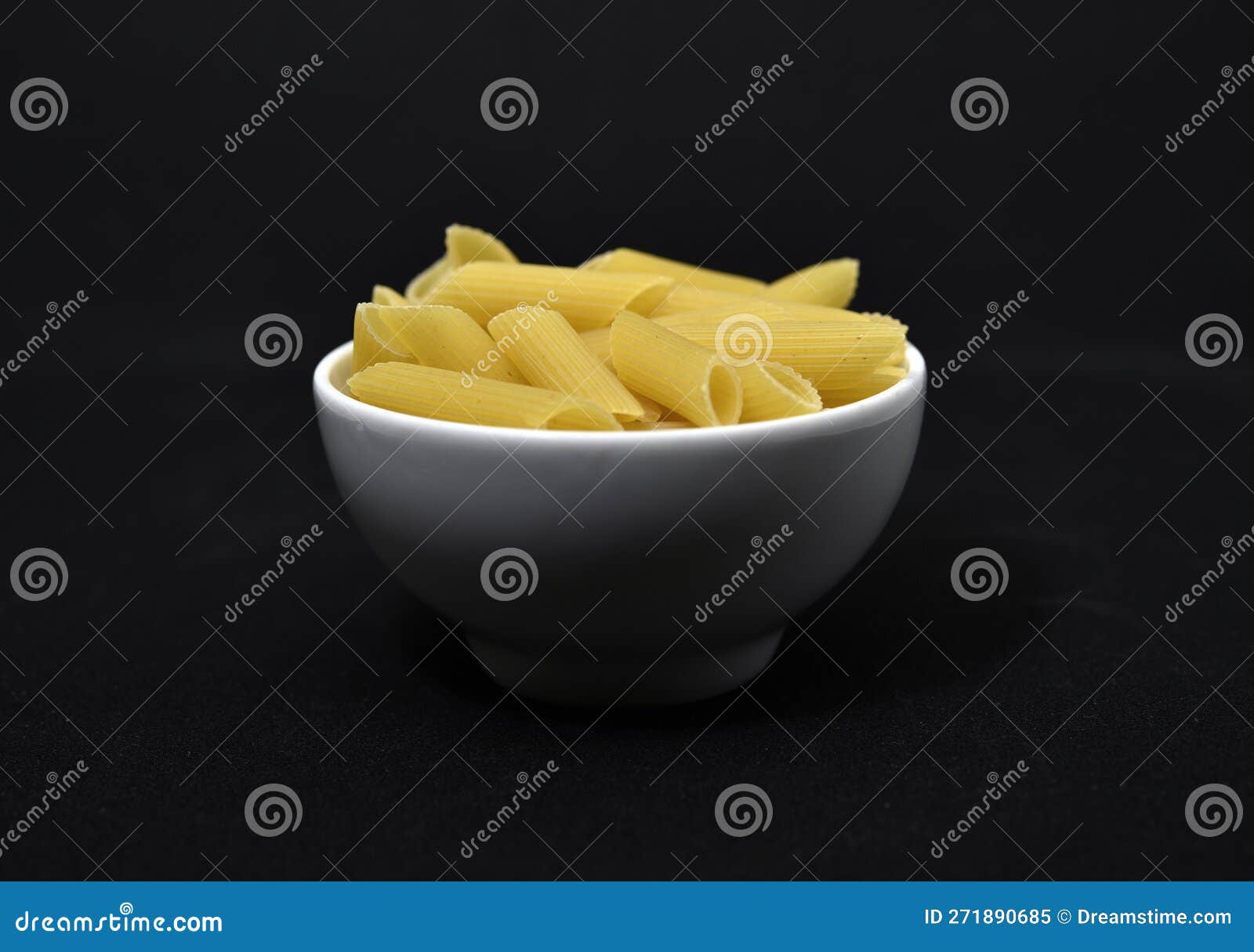 Wheat Pasta in a White Bowl on a Black Background. Dry Pasta Stock ...