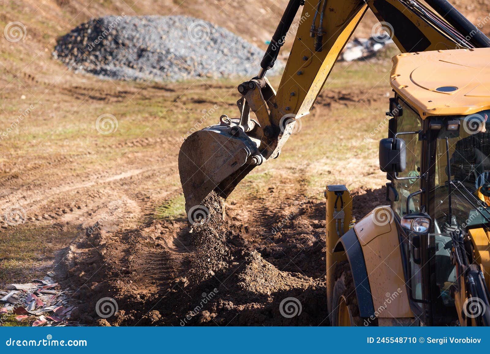 Wheel Excavator Loader is Digging the Soil at the Construction Site ...