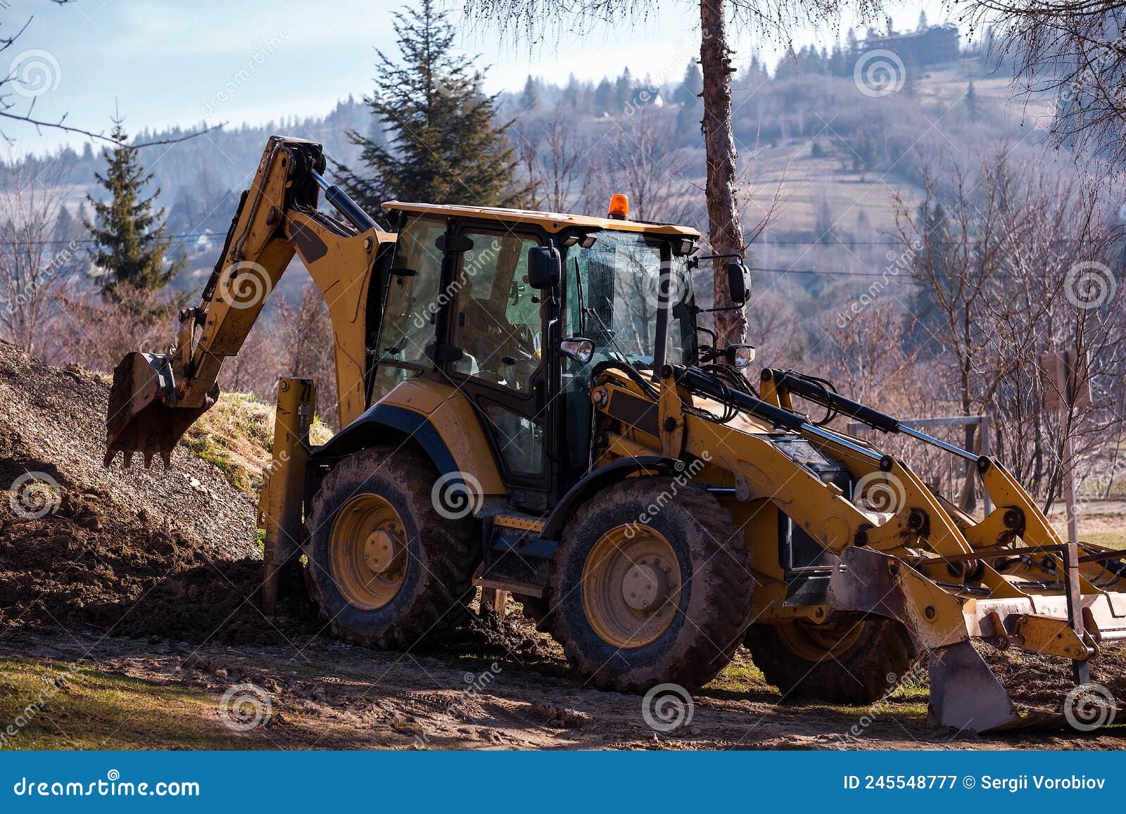 Wheel Excavator Loader is Digging the Soil at the Construction Site ...