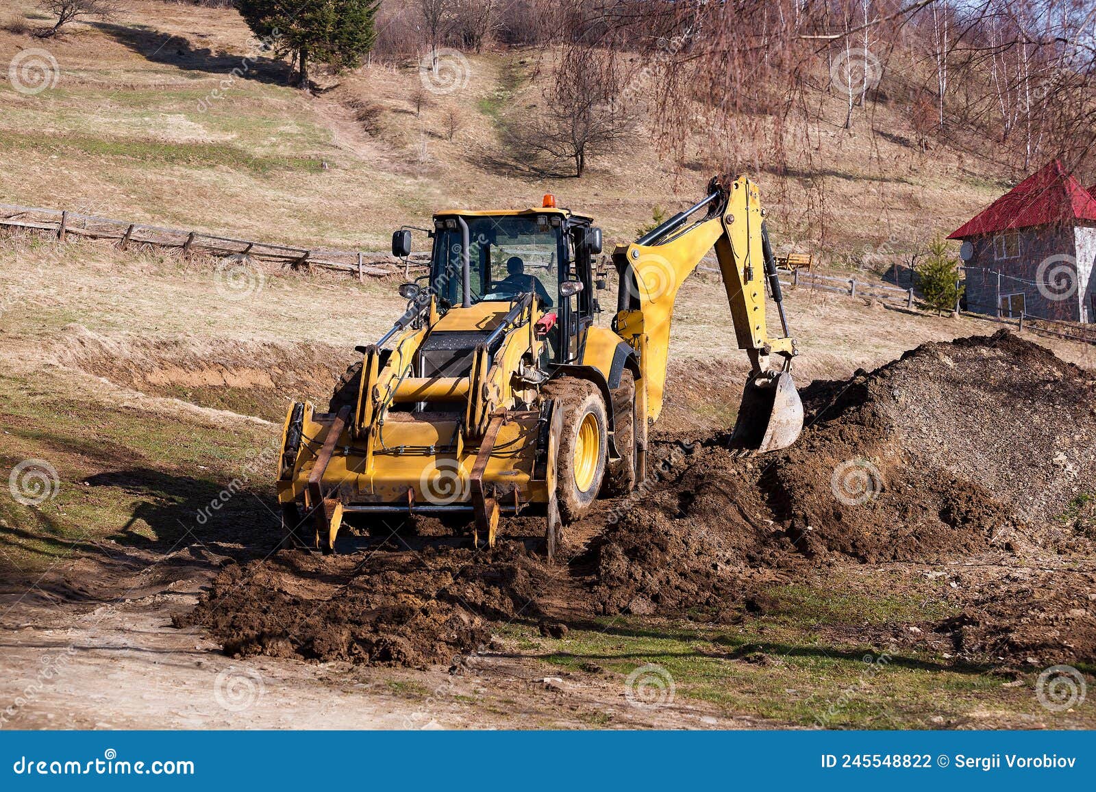 Wheel Excavator Loader is Digging the Soil at the Construction Site ...