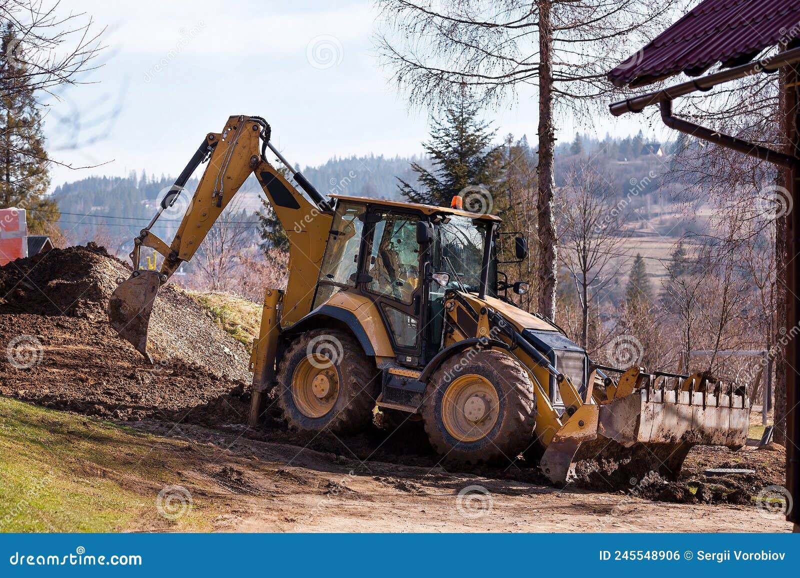 Wheel Excavator Loader is Digging the Soil at the Construction Site ...