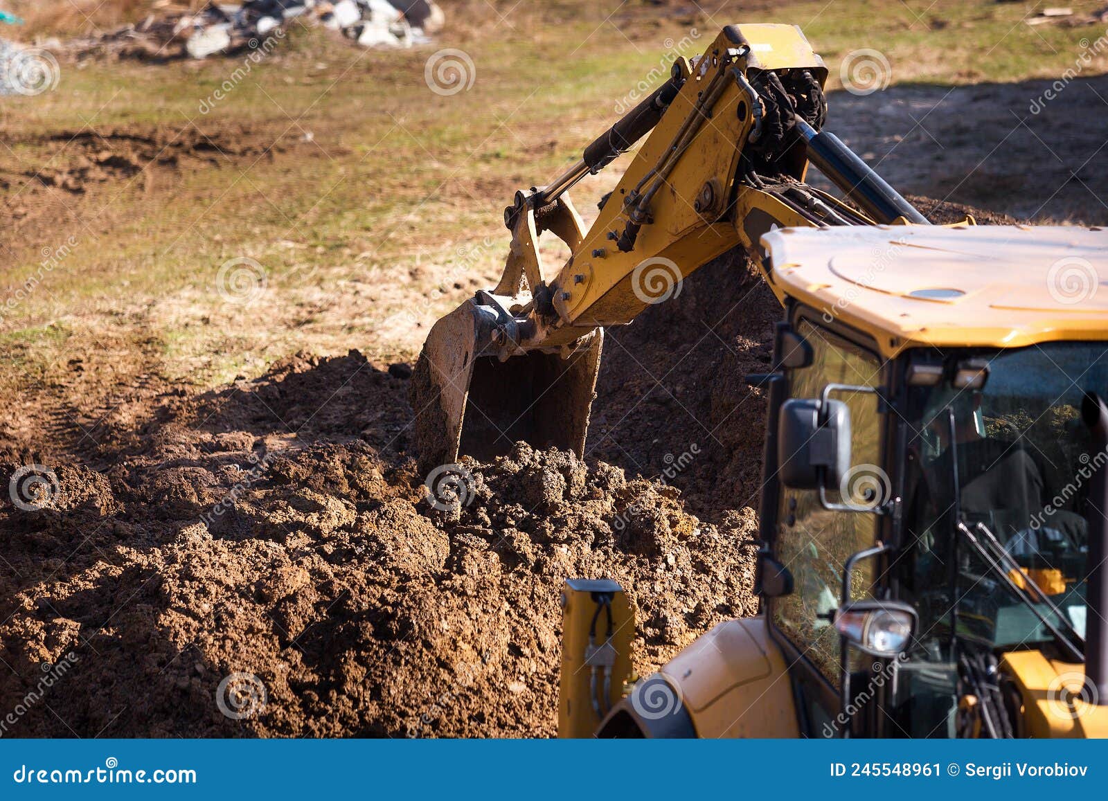 Wheel Excavator Loader is Digging the Soil at the Construction Site ...