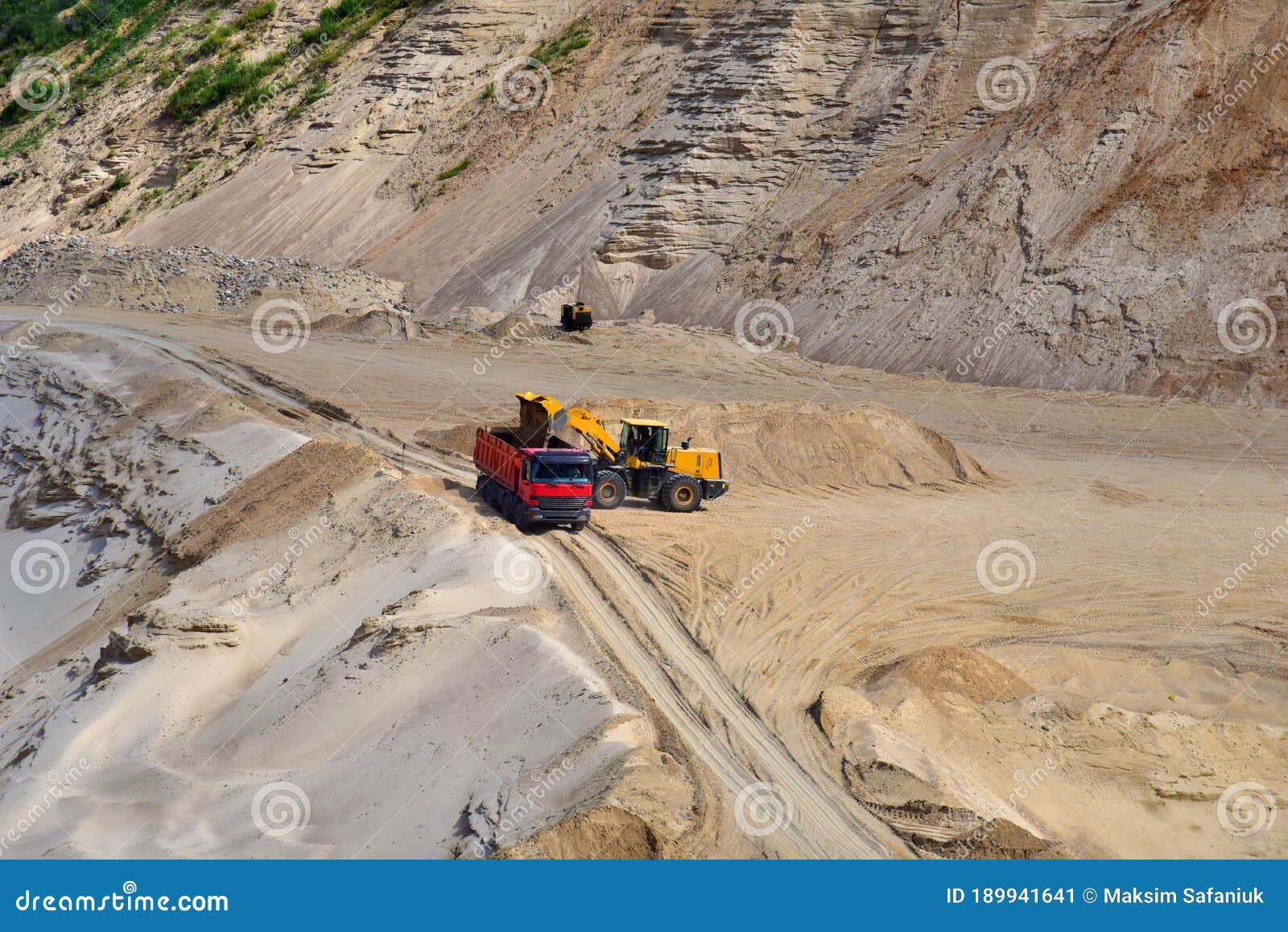 Wheel Front-end Loader Loading Sand into Heavy Dump Truck at the ...