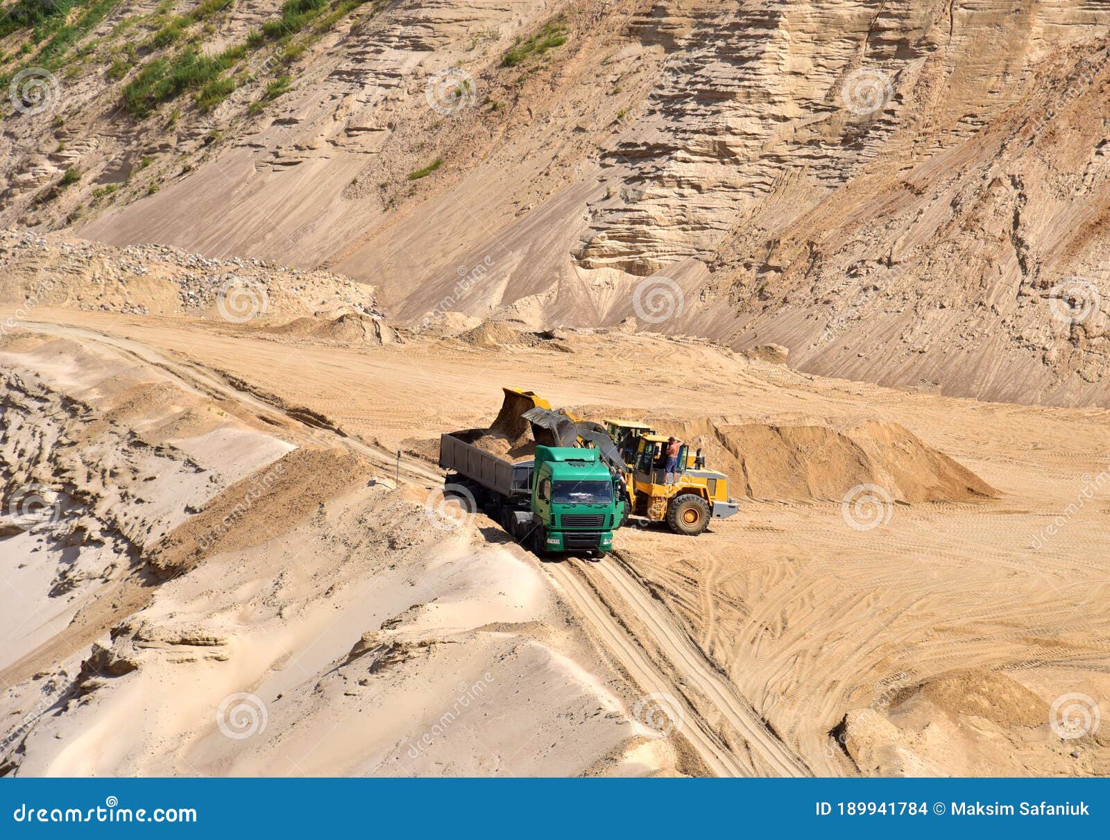 Wheel Front-end Loader Loading Sand into Heavy Dump Truck at the ...