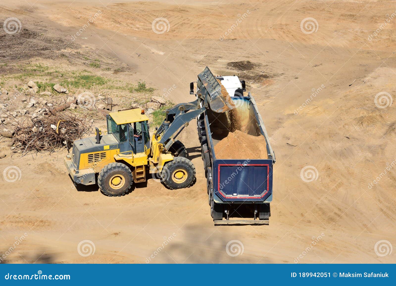 Wheel Front-end Loader Loading Sand into Heavy Dump Truck at the ...