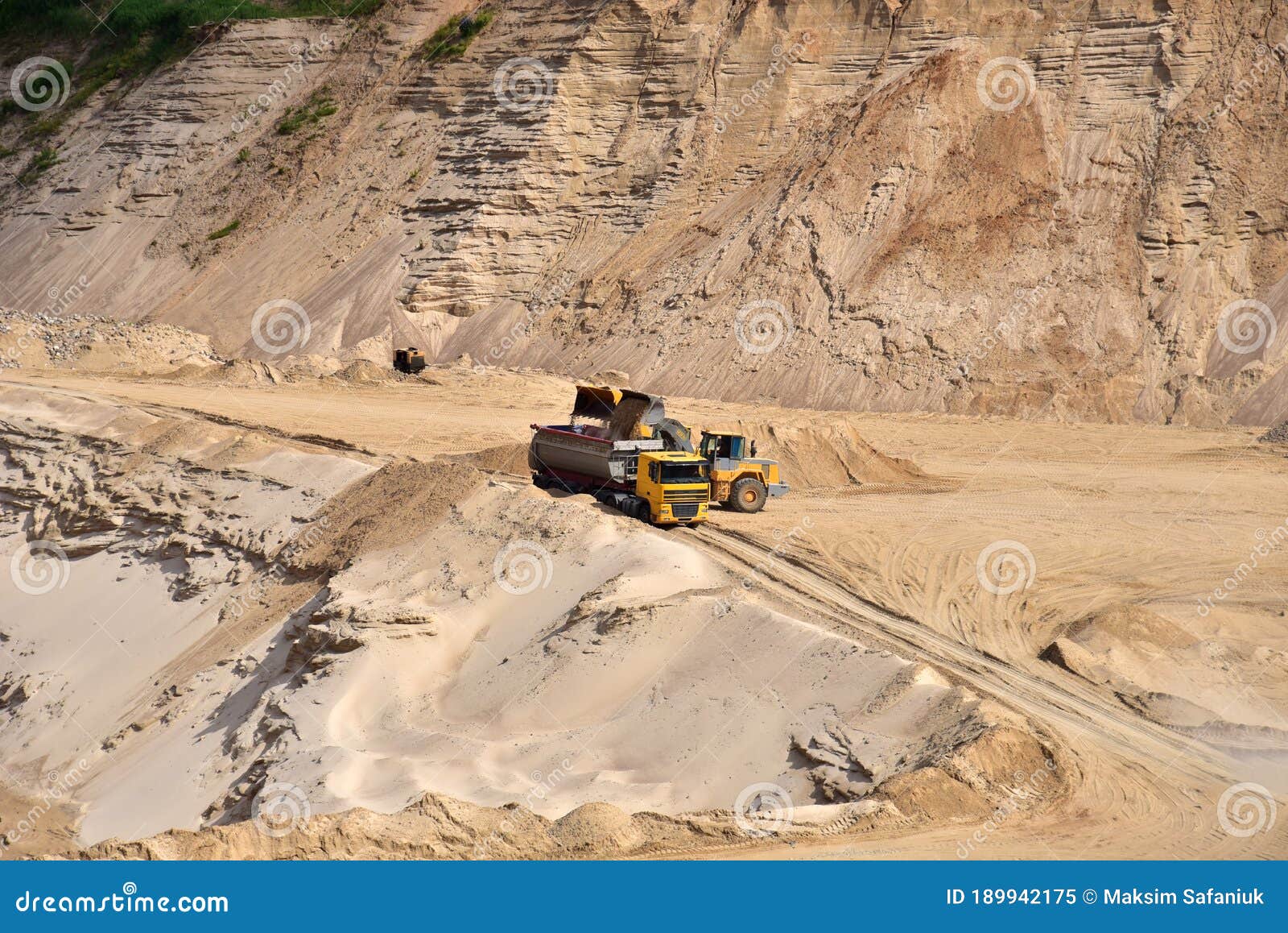 Wheel Front-end Loader Loading Sand into Heavy Dump Truck at the ...