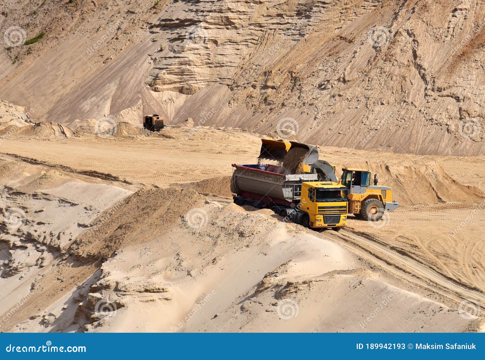 Wheel Front-end Loader Loading Sand into Heavy Dump Truck at the ...