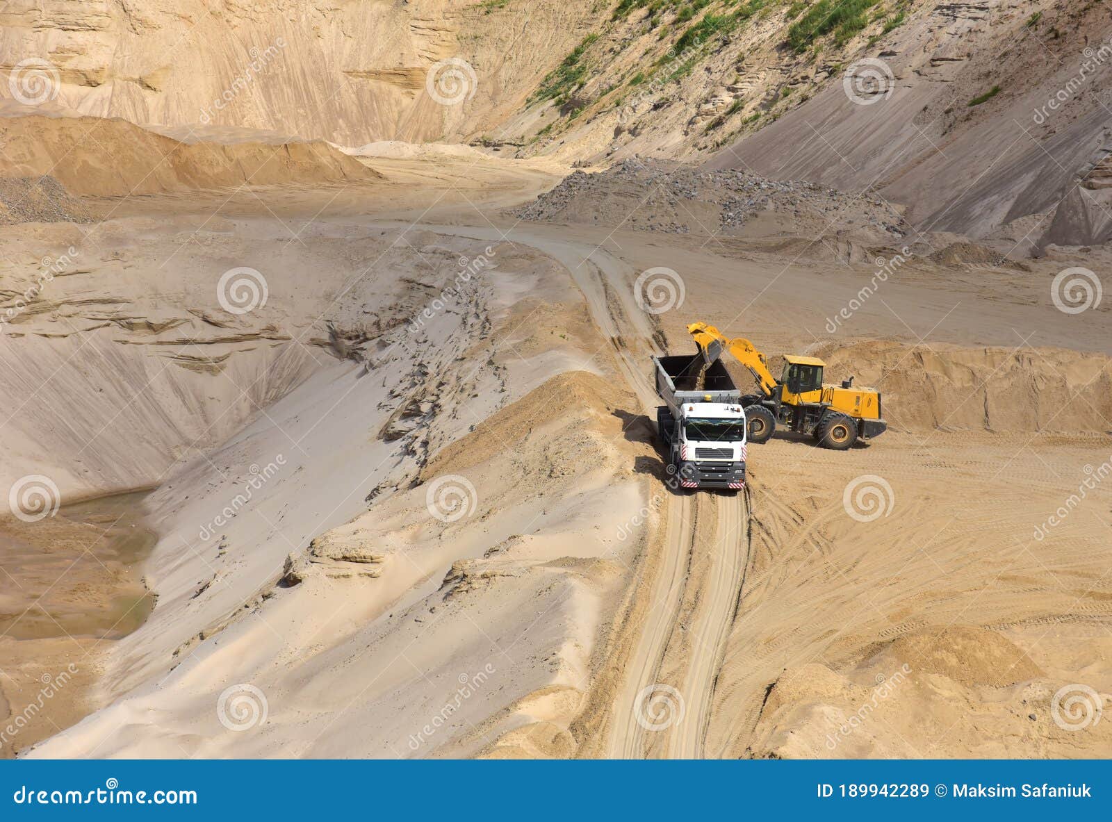 Wheel Front-end Loader Loading Sand into Heavy Dump Truck at the ...