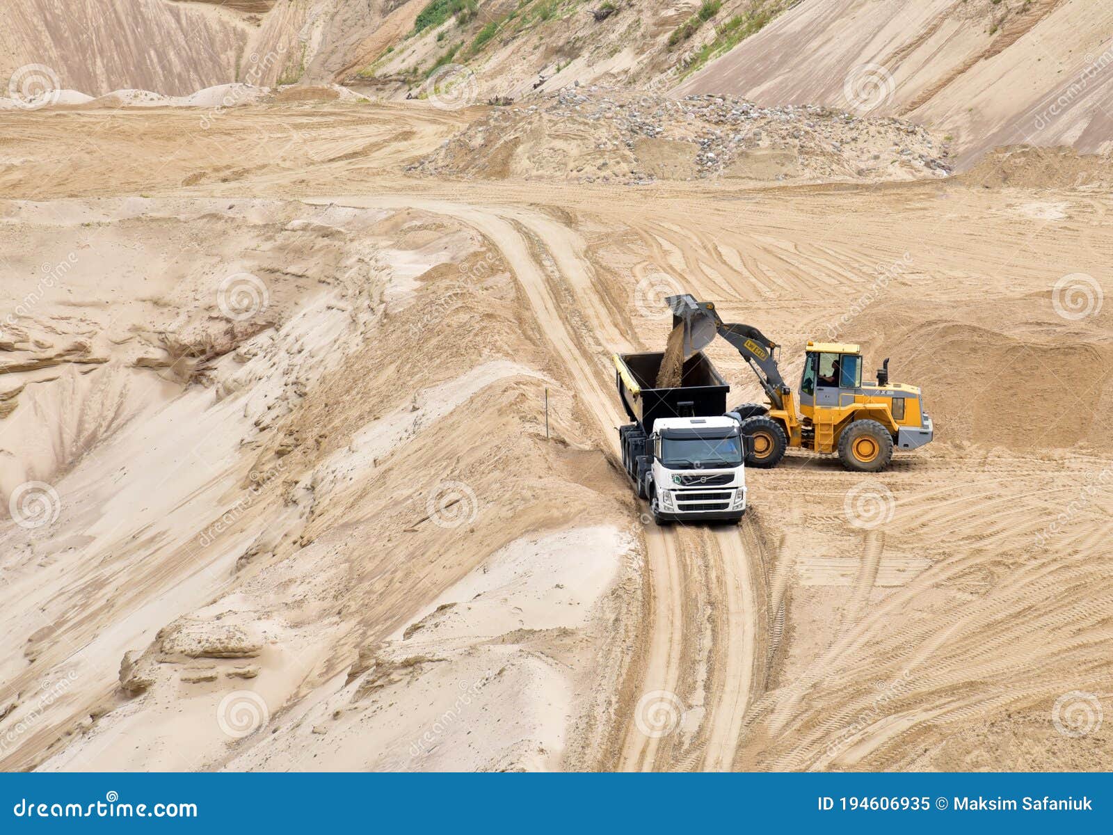Wheel Front-end Loader Loading Sand into Heavy Dump Truck at the ...