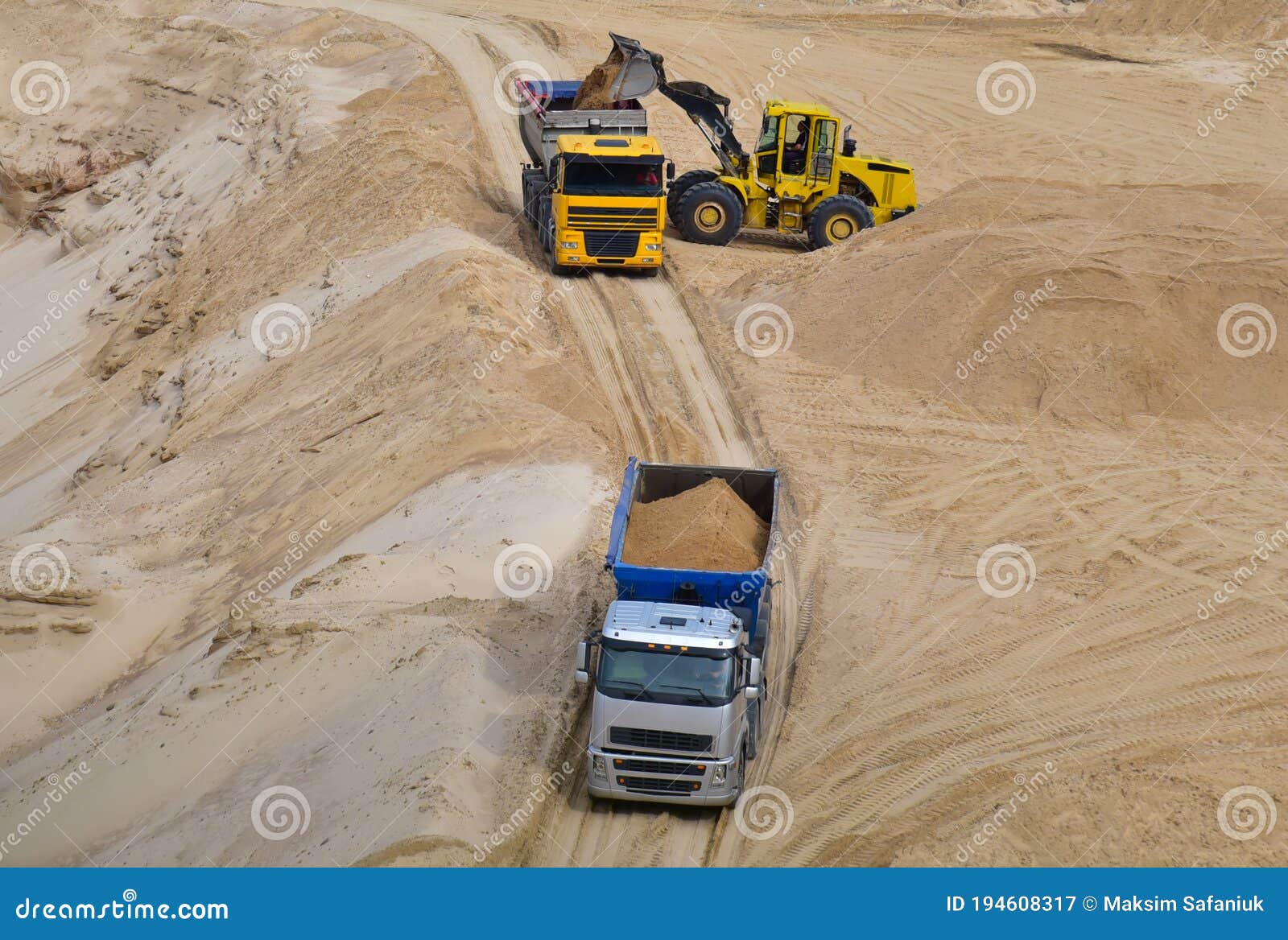 Wheel Front-end Loader Loading Sand into Heavy Dump Truck at the ...