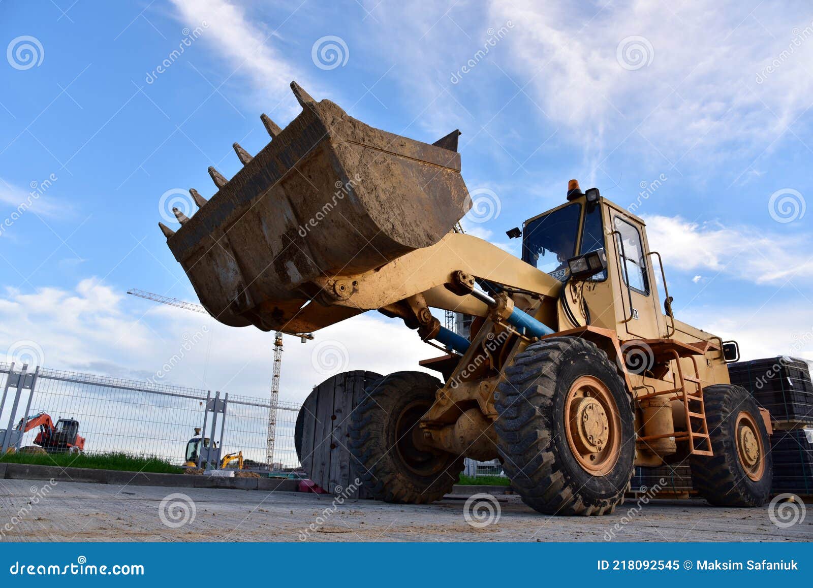 Wheel Loader with a Bucket at Construction. Heavy Machinery for Loading ...