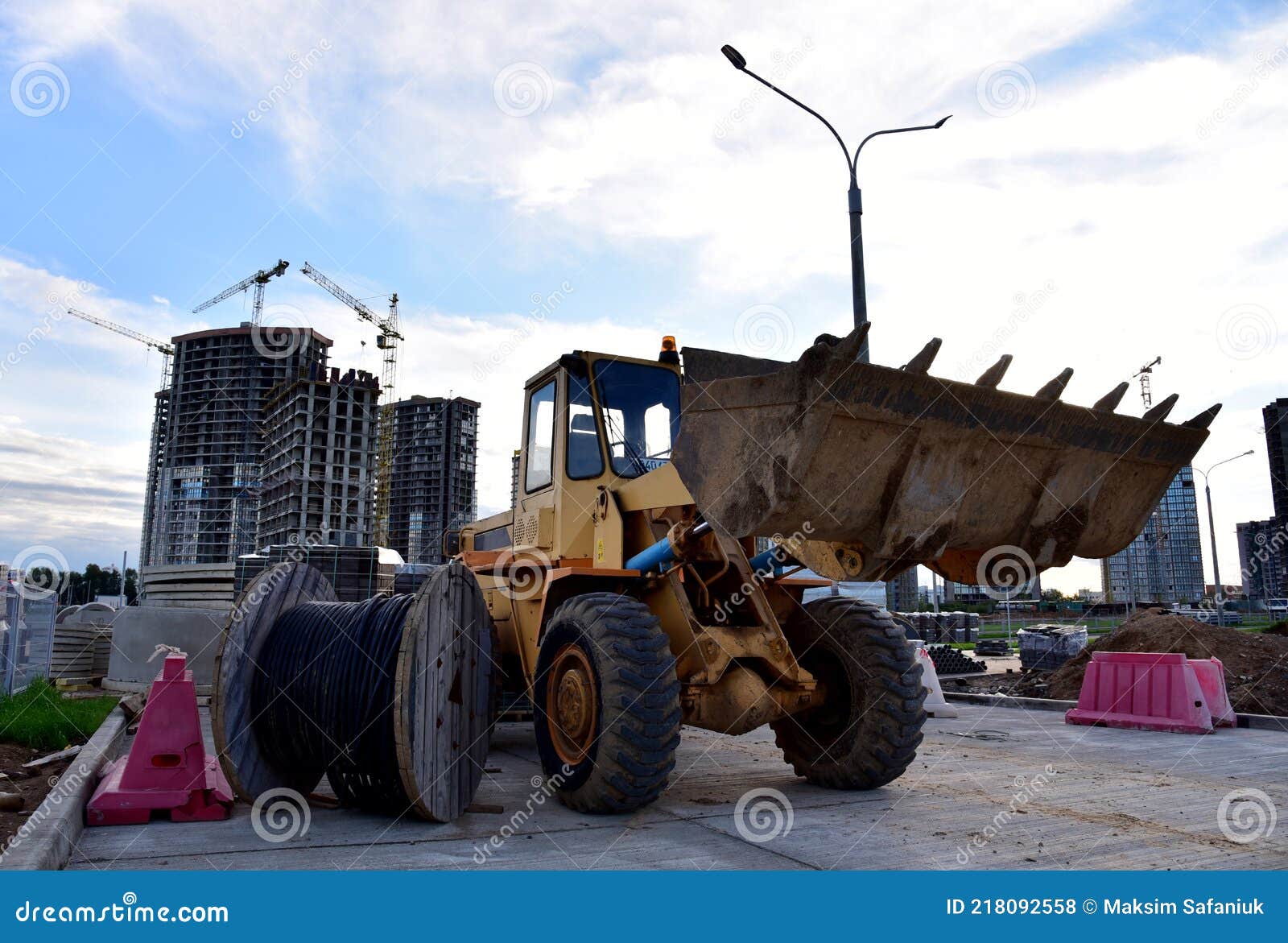 Wheel Loader with a Bucket at Construction. Heavy Machinery for Loading ...