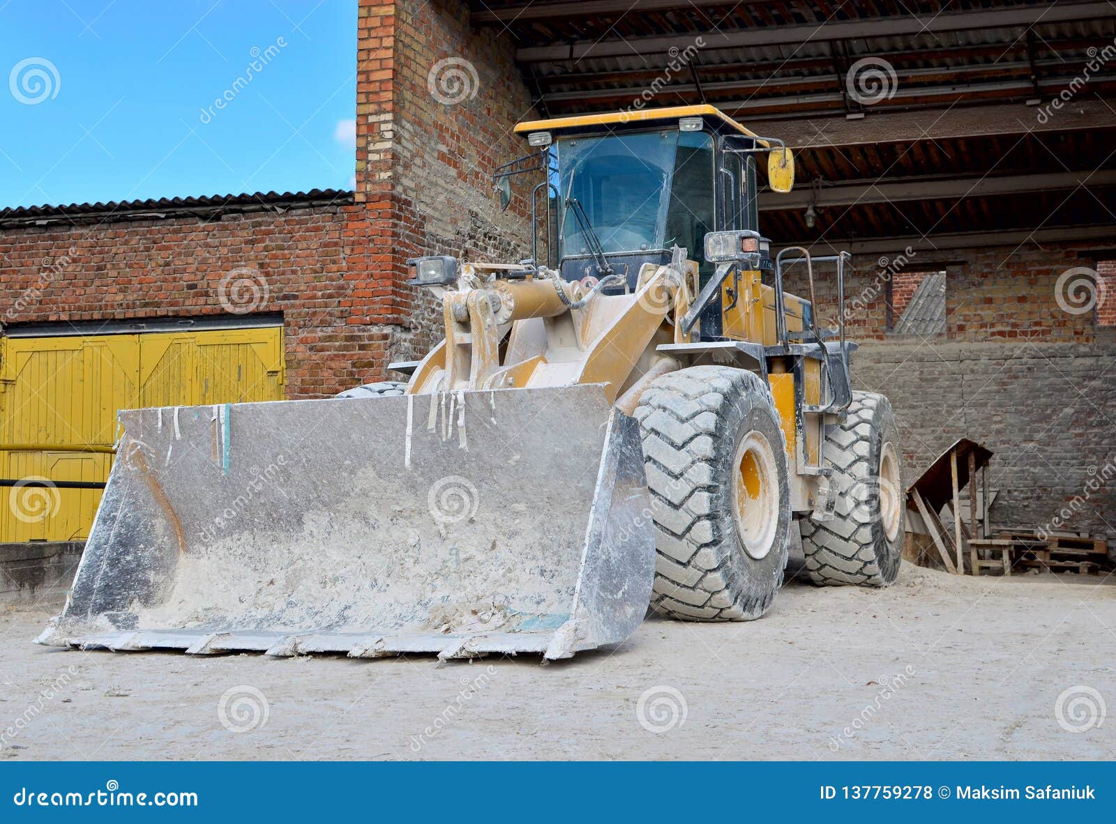 Wheel Loader on a Construction Site. Diesel Bulldozer with Bucket Stock ...