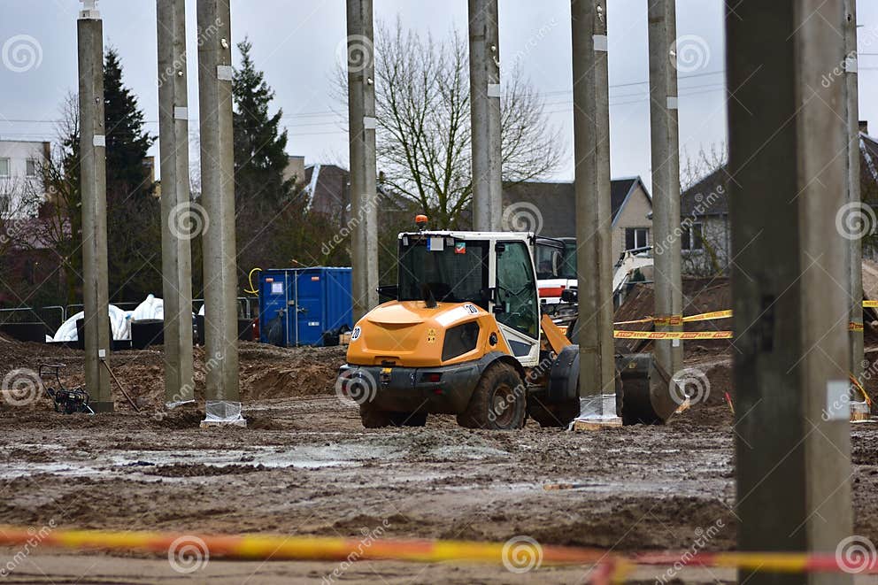 Wheel Loader Digging and Pushing Ground Around Building Columns. Stock ...