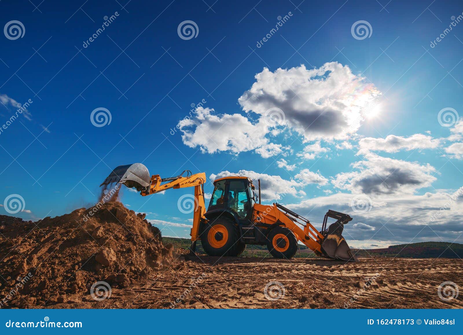 Excavator During Earthmoving At Construction Site On Sunset Background ...
