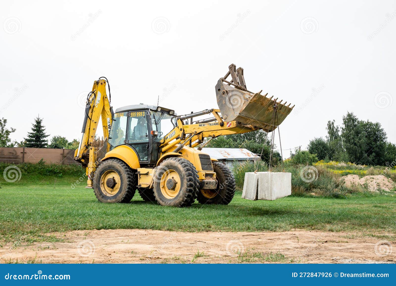 Wheel Loader. Excavator Install the Foundation Blocks into a Trench ...
