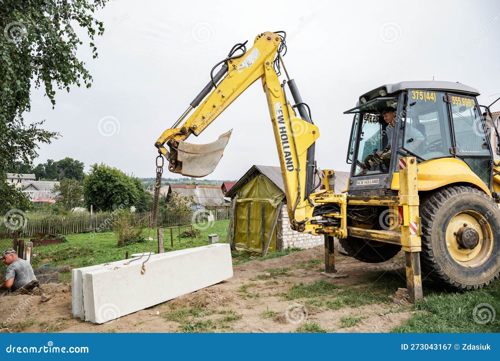 Wheel Loader. Excavator Install the Foundation Blocks into a Trench ...
