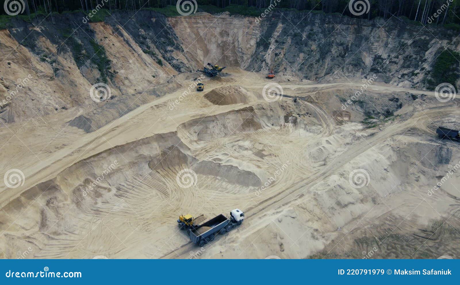 Wheel Loader Loading Sand into Dump Truck in Open Pit Mine. Arial View ...
