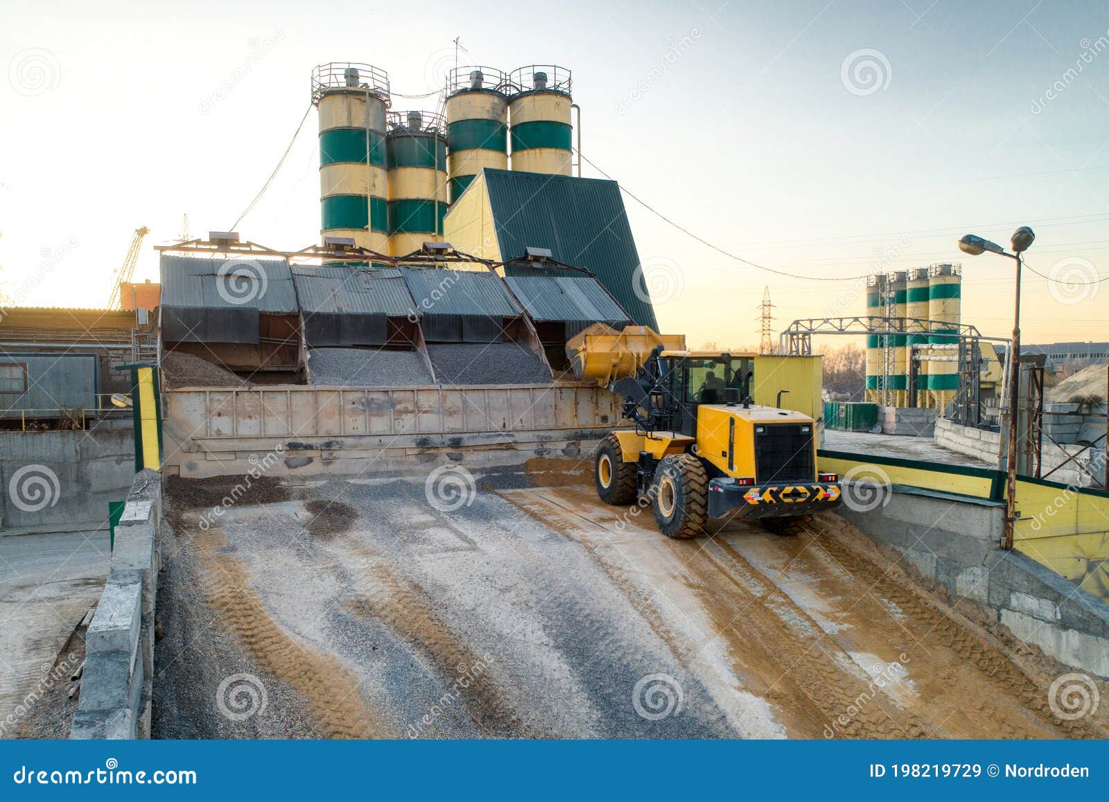 A Wheel Loader Loads Sand into a Silo. Stock Image - Image of ...