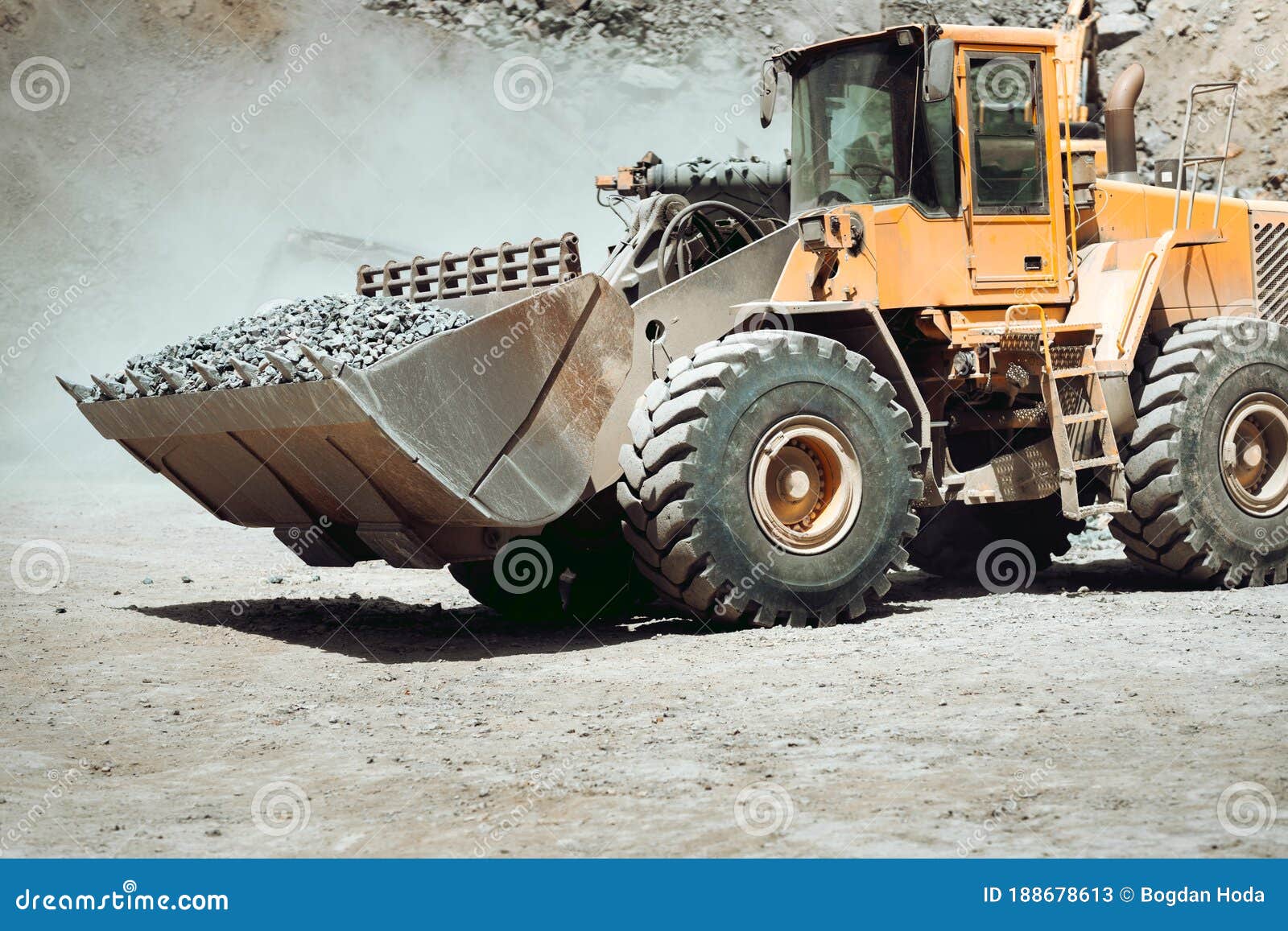 Large Wheel Loader on Quarry Site Transporting and Loading Gravel into ...
