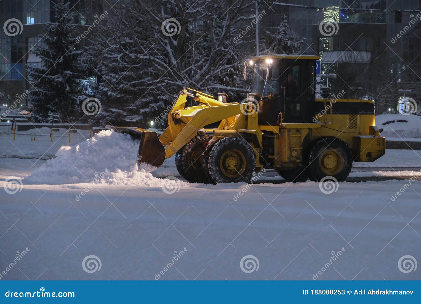 Wheel Loader is Removing Snow at Night during Snowfall. Selective Focus ...