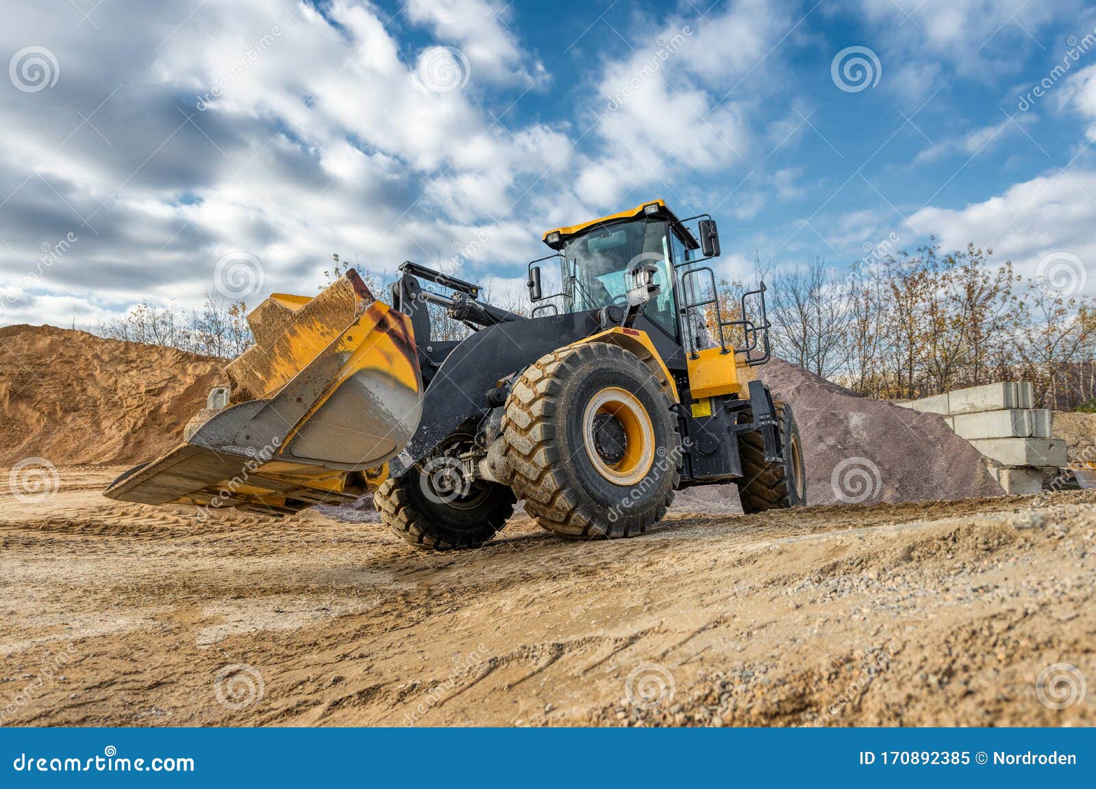 Wheel Loader Rides on a Construction Site. Stock Image - Image of ...