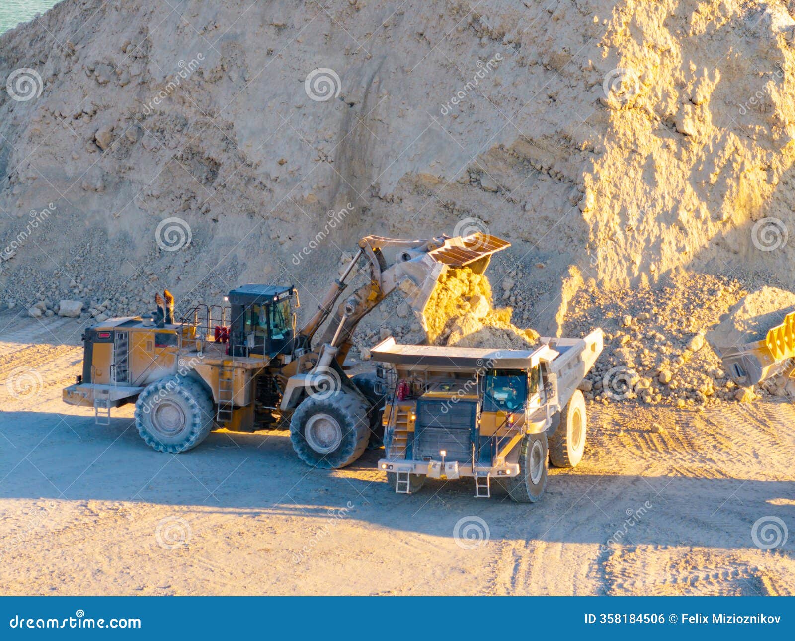 Wheel Loaders Loading Rock into a Dump Truck at a Quarry Stock Photo ...