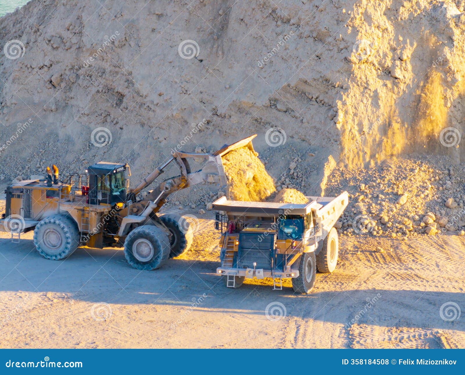 Wheel Loaders Loading Rock into a Dump Truck at a Quarry Stock Photo ...